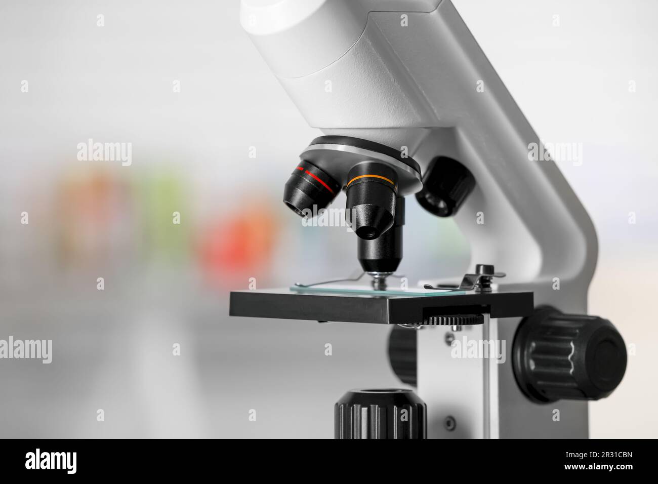 Modern medical microscope with glass slide on blurred background ...