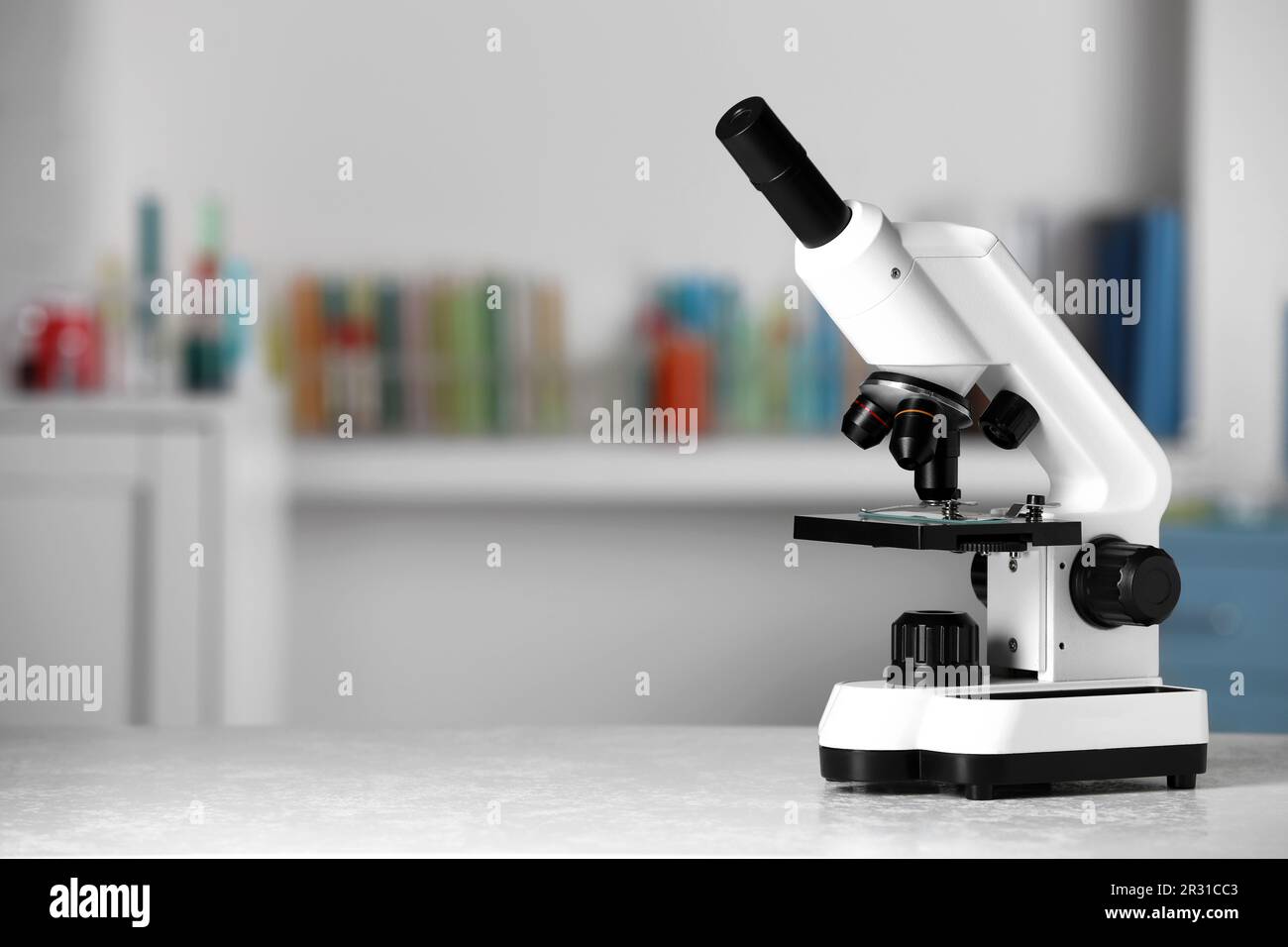 Modern medical microscope on white table in laboratory, space for text ...