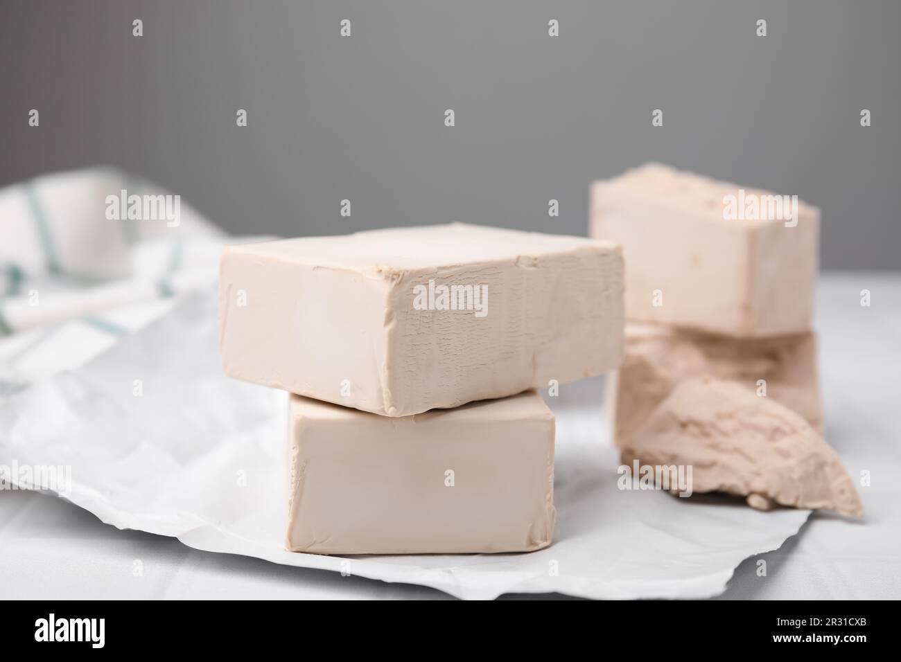 Blocks of compressed yeast on white table, closeup Stock Photo - Alamy