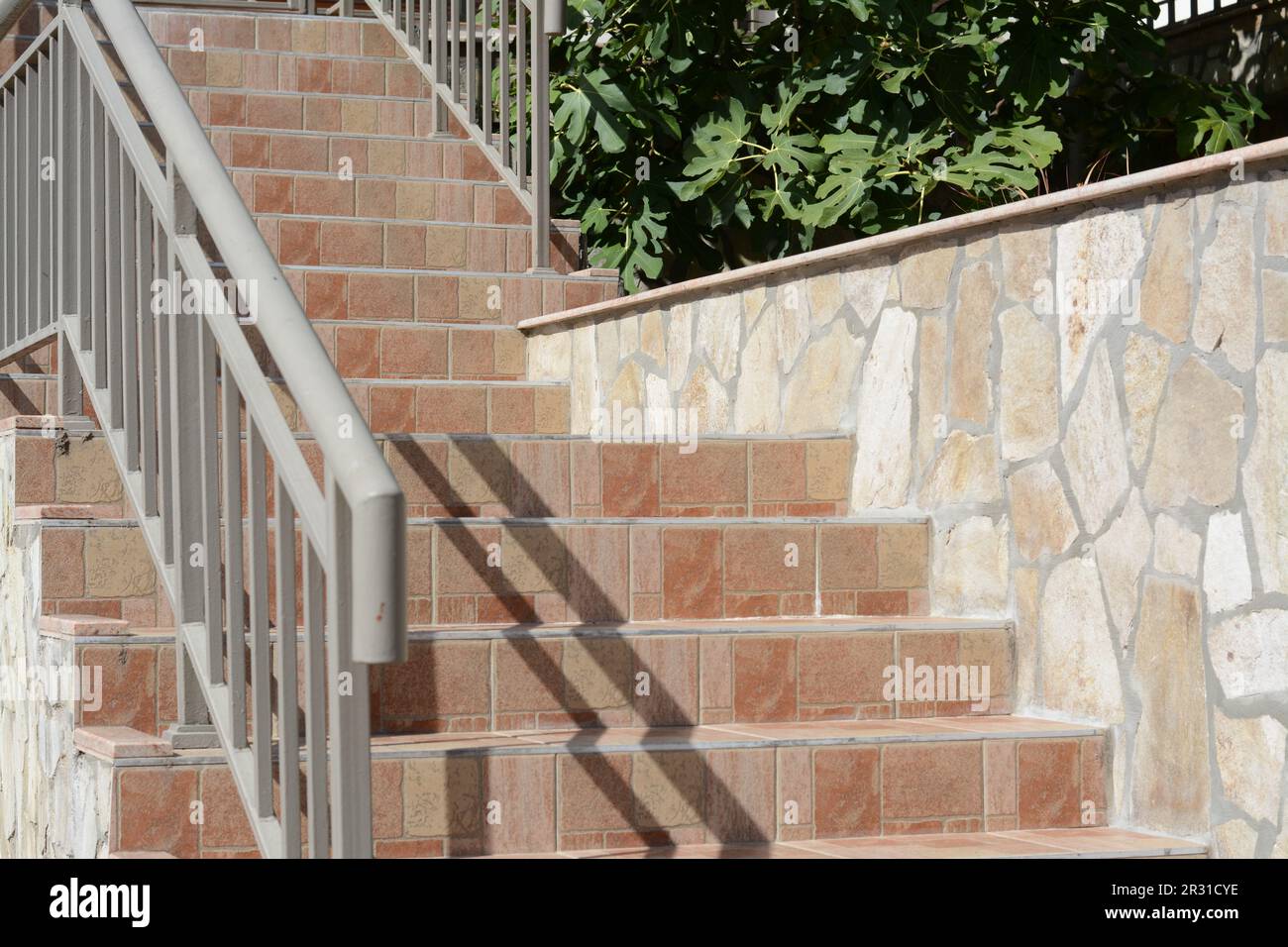 Beautiful tiled stairs with metal railings outdoors Stock Photo - Alamy