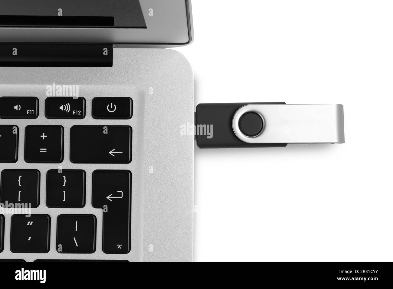 Modern usb flash drive attached into laptop on white background, top ...