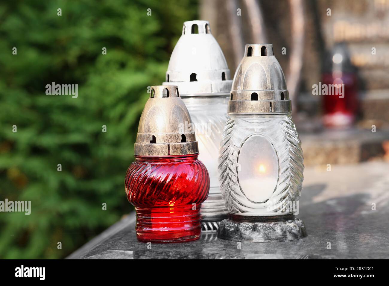 Grave lanterns on granite surface in cemetery Stock Photo - Alamy