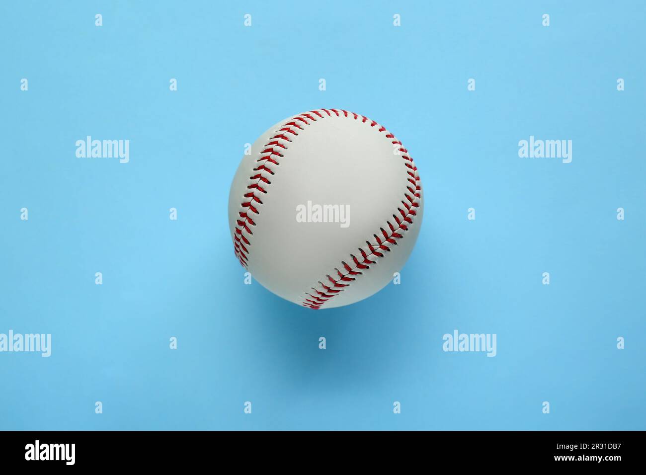 Baseball ball on light blue background, top view. Sports game Stock ...