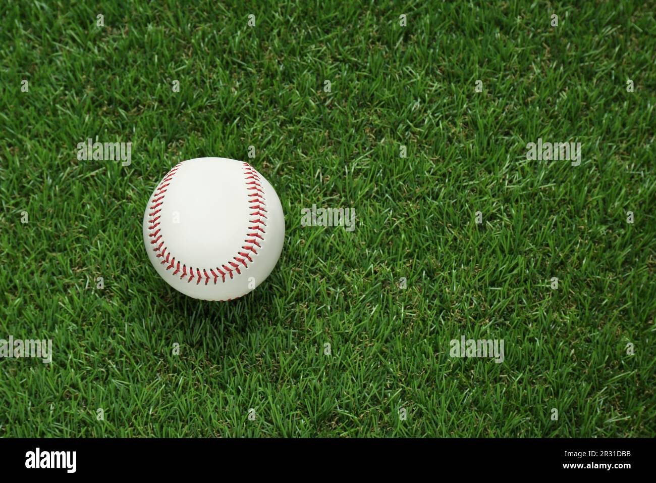 Baseball ball on green grass, top view with space for text. Sports game ...