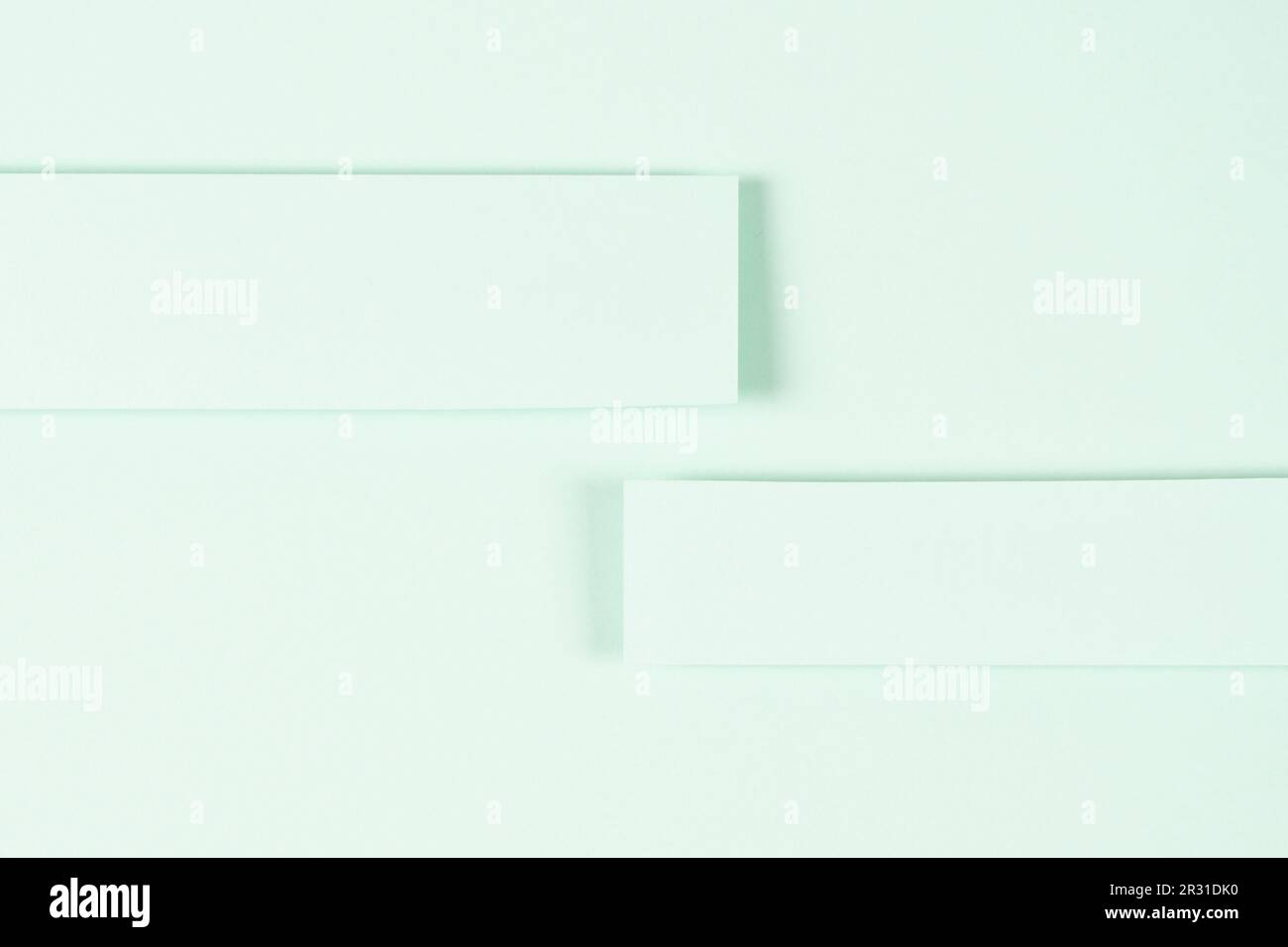 Light green paper background. Blank paper strips on pastel green ...