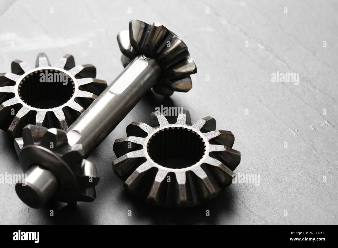 Different stainless steel gears on light grey background, closeup ...