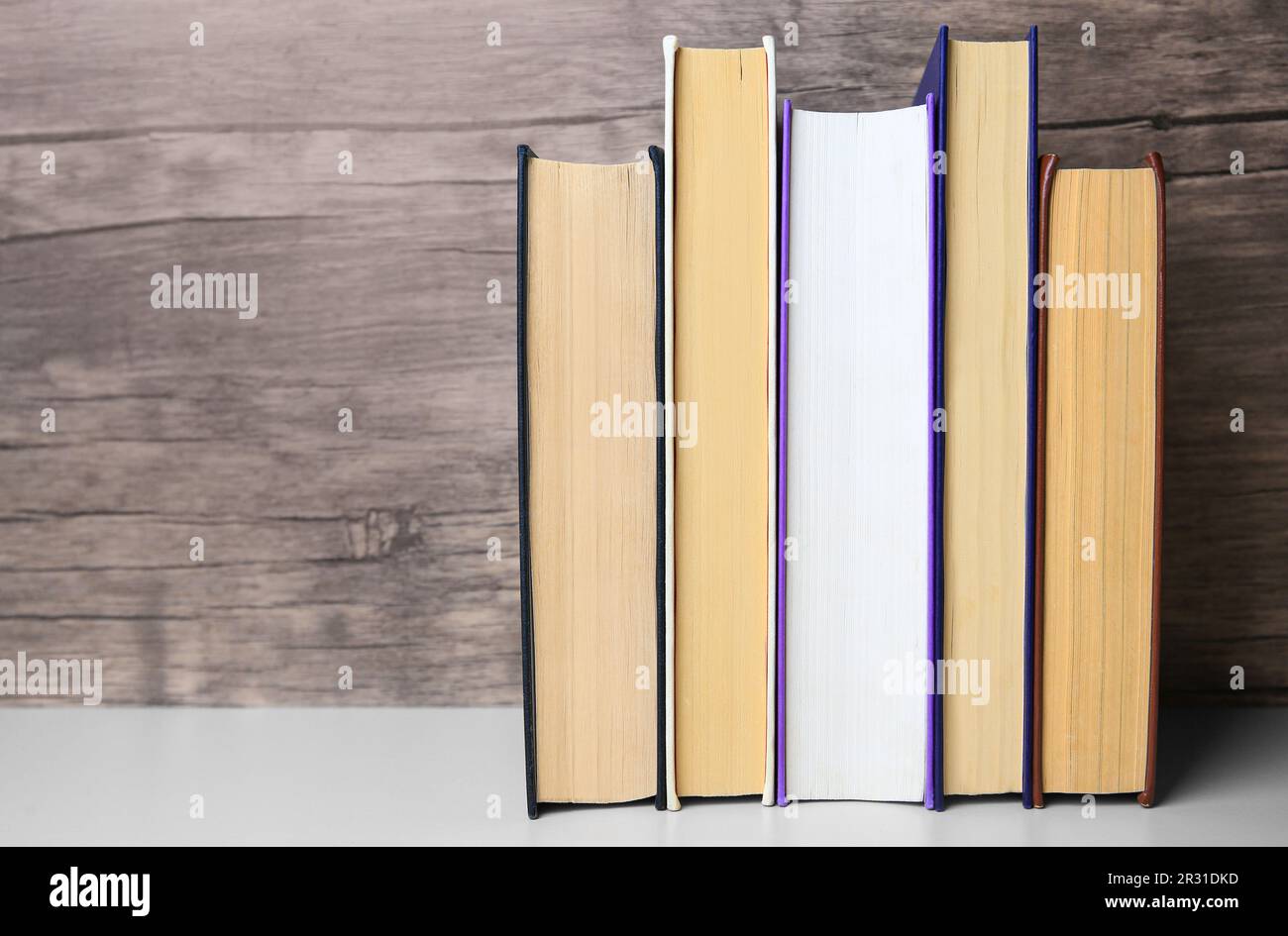 Collection of different books on white shelf, space for text Stock ...