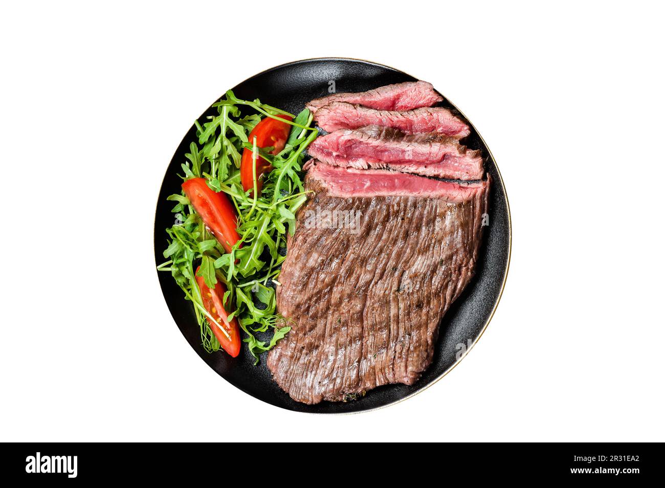 Grilled medium rare flank beef steak with salad in a plate. Isolated on ...