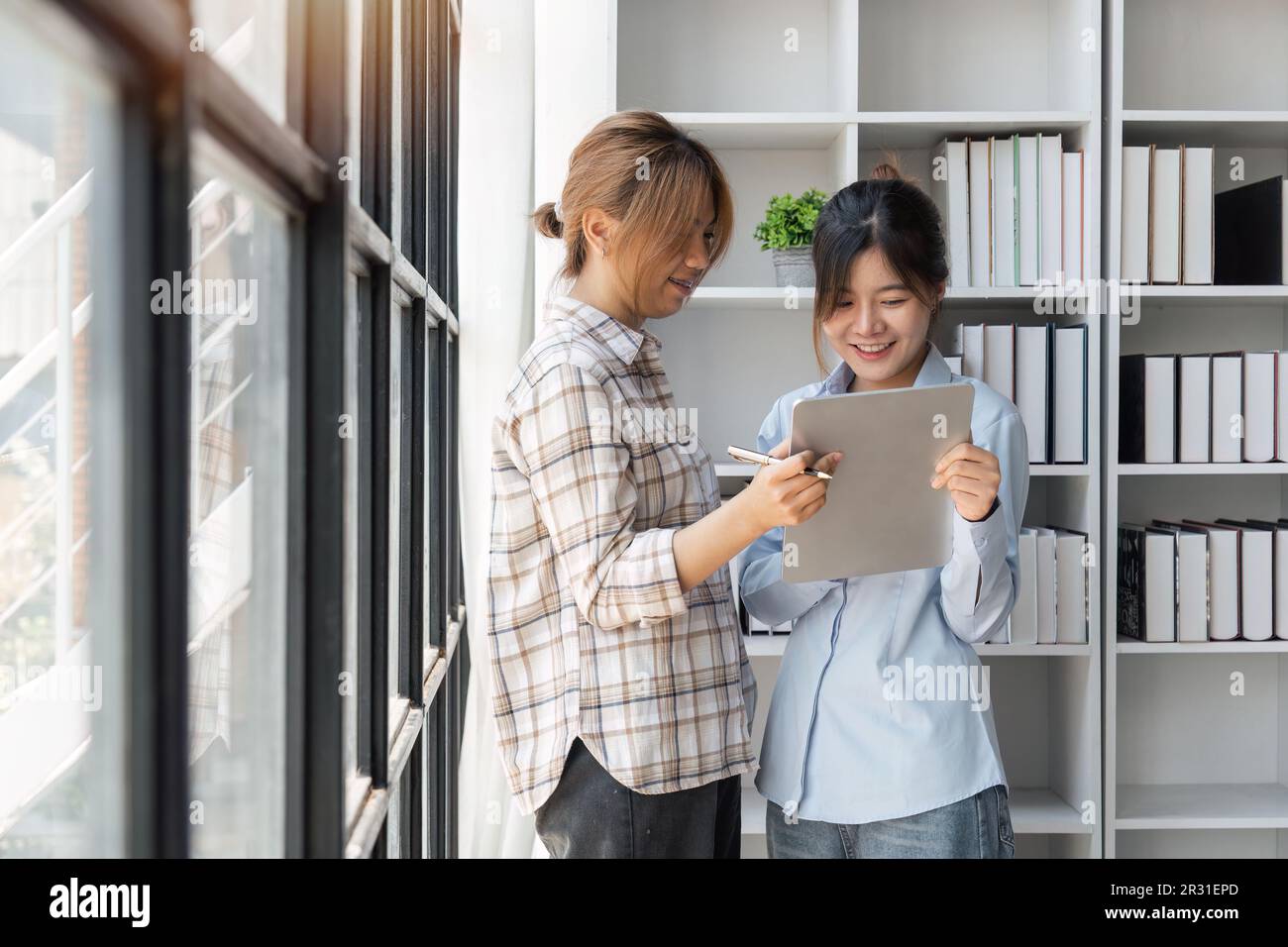 happy students couple in school library have discussion about project ...