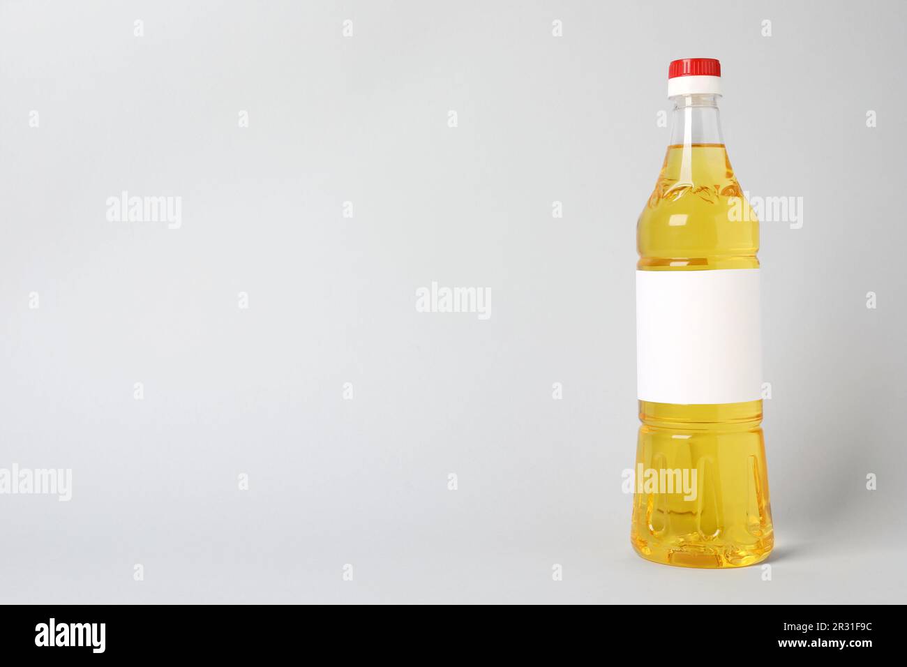 Bottle of cooking oil on light grey background. Space for text Stock ...