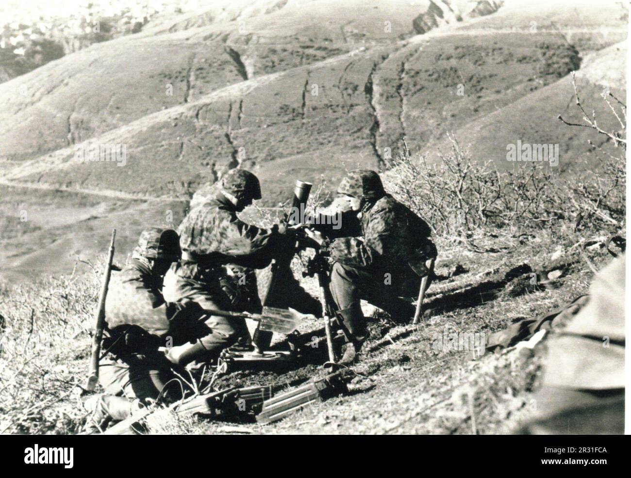 World War Two B&W photo German Waffen SS troops in Camo Smocks set up a ...