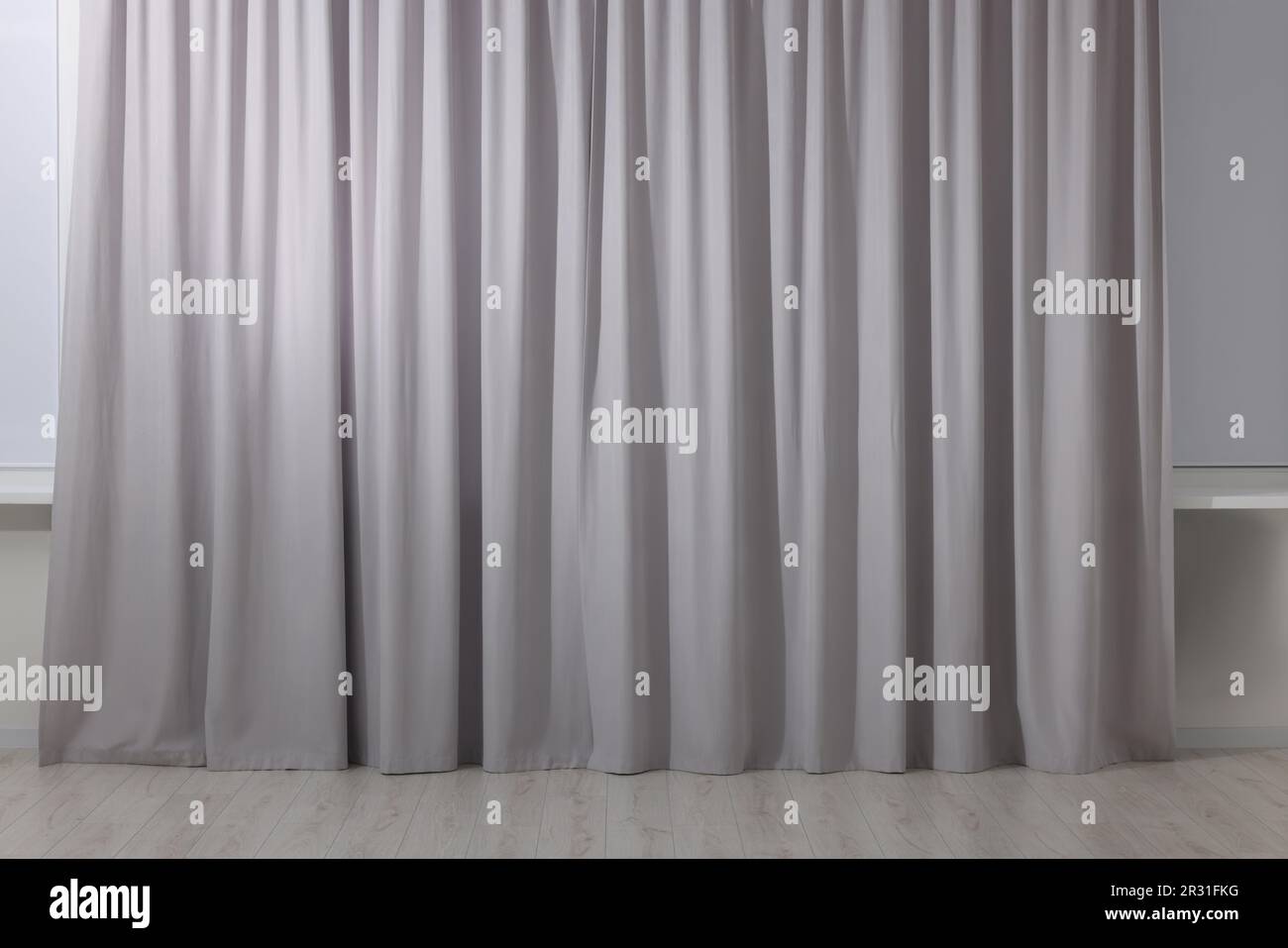 Light grey window curtains in living room Stock Photo - Alamy