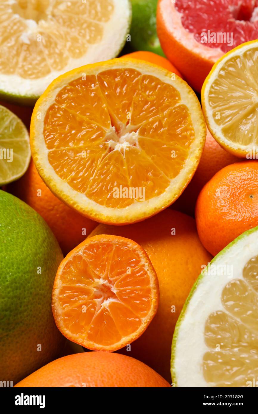 Different ripe citrus fruits as background, closeup Stock Photo - Alamy
