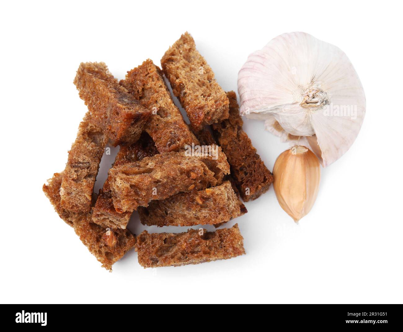 Delicious crispy rusks and garlic on white background, top view Stock ...