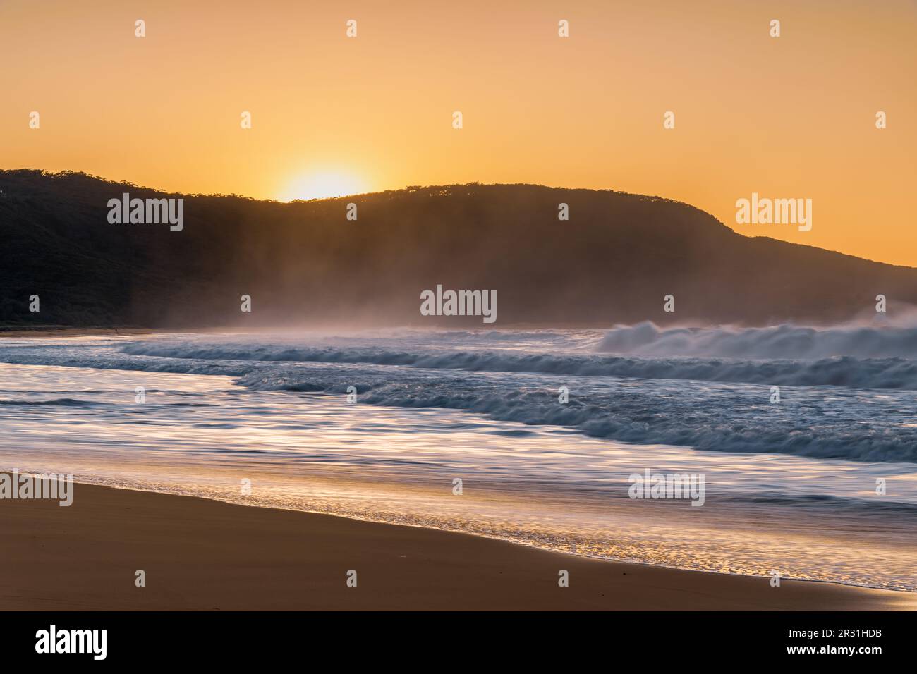 Sunrise seascape with large waves washing ashore at Killcare Beach on ...