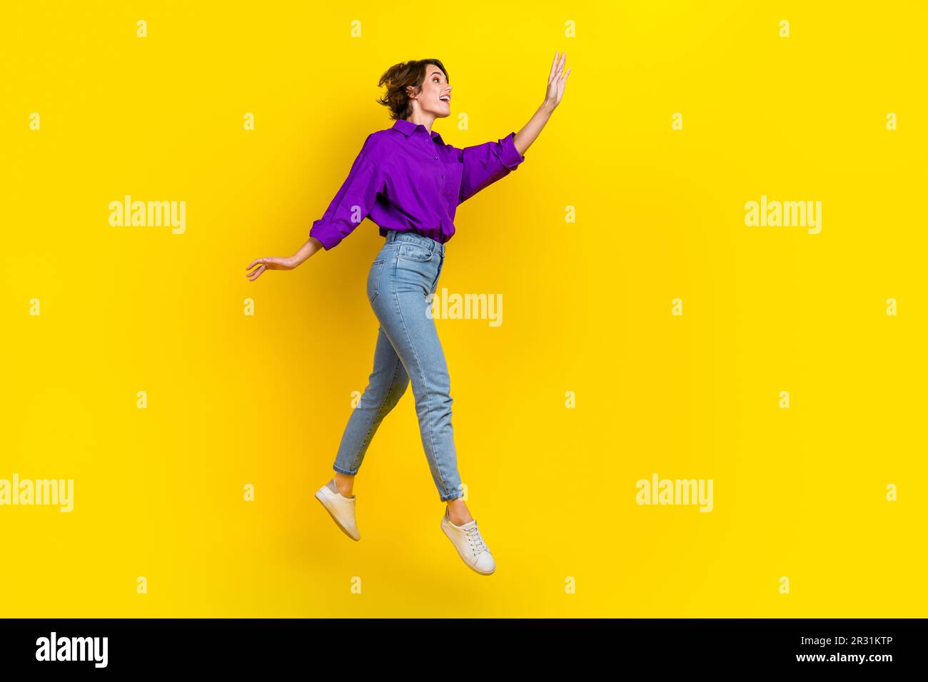 Full length photo of dreamy excited woman dressed purple shirt jumping ...
