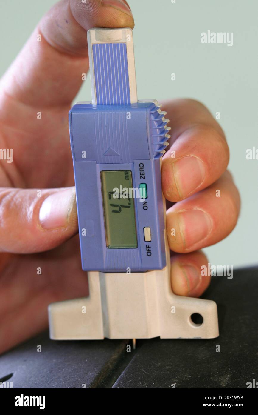 Measuring device for testing the tread depth of tires Stock Photo - Alamy