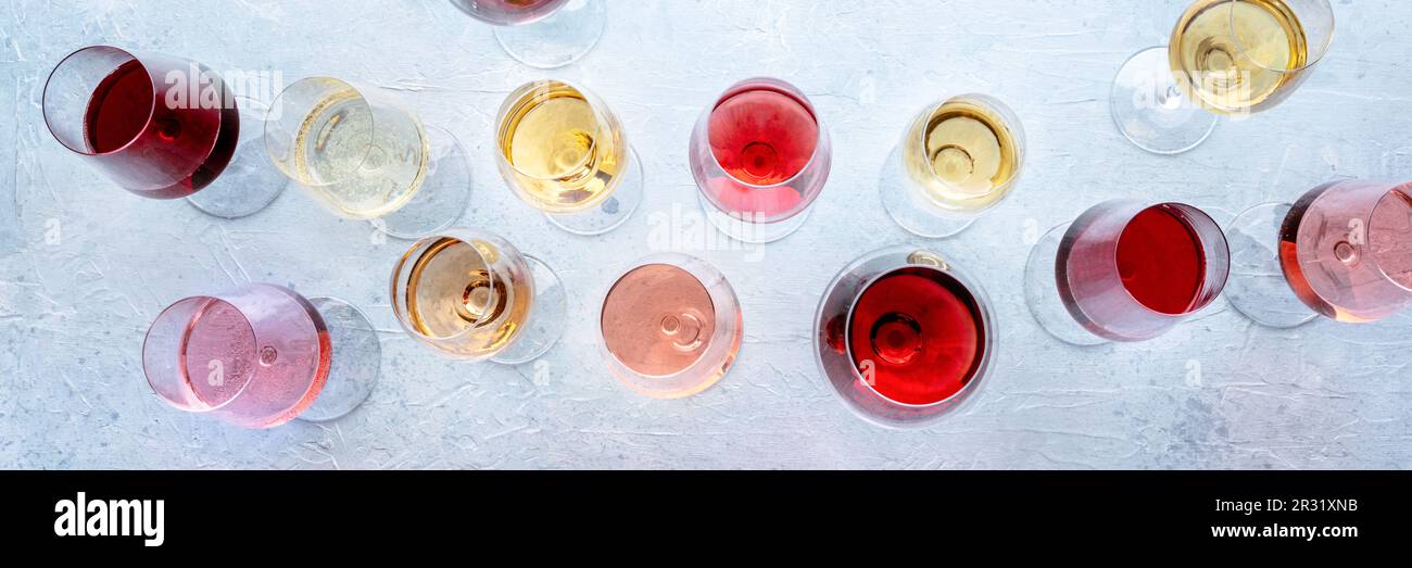 Wine glasses at a tasting panorama. Rose, red, and white wine, drinks ...
