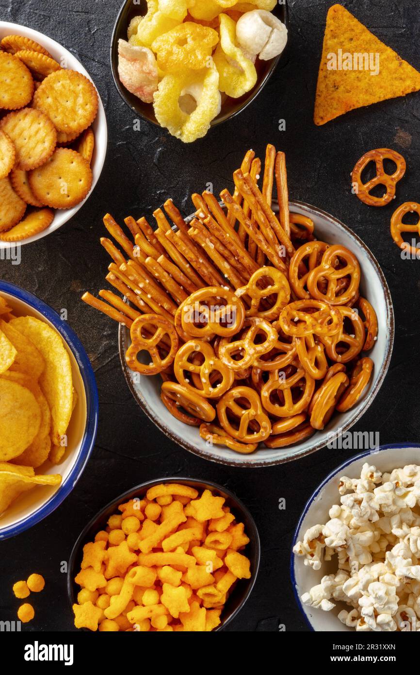 Salty snacks, party mix, shot from the top. An assortment of appetizers ...