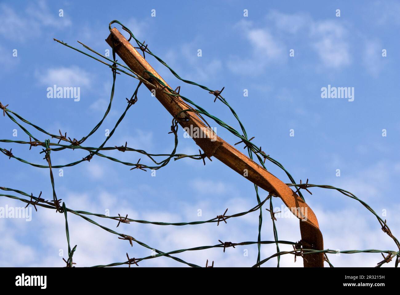 Barbed wire and iron posts Stock Photo - Alamy