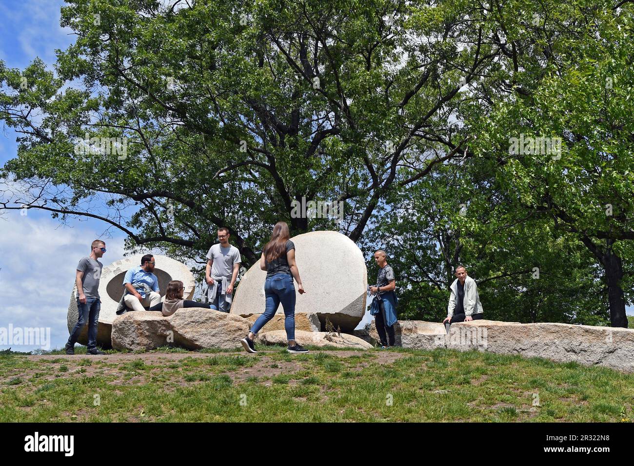 New York, USA. 21st May, 2023. Visitors sit on Isamu Noguchi's artwork "Momo Taro" at Storm King ...