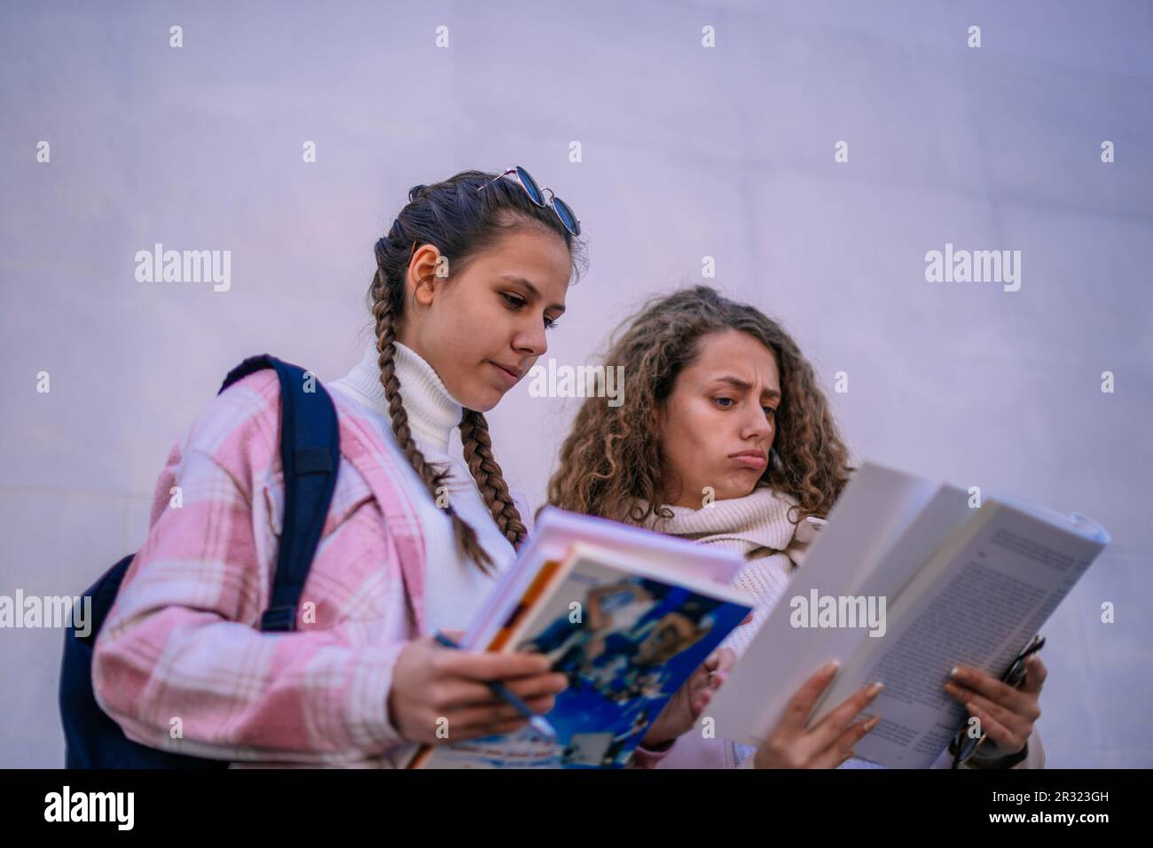 Beautiful school girls reviewing subject before exam. Close up Stock ...