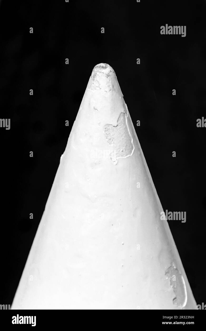 White cone against black background Stock Photo - Alamy
