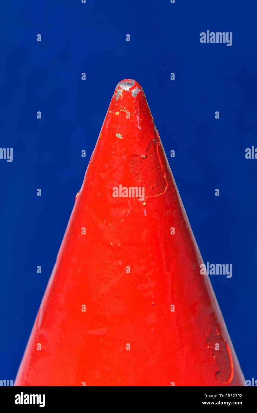 Red cone against blue background Stock Photo - Alamy