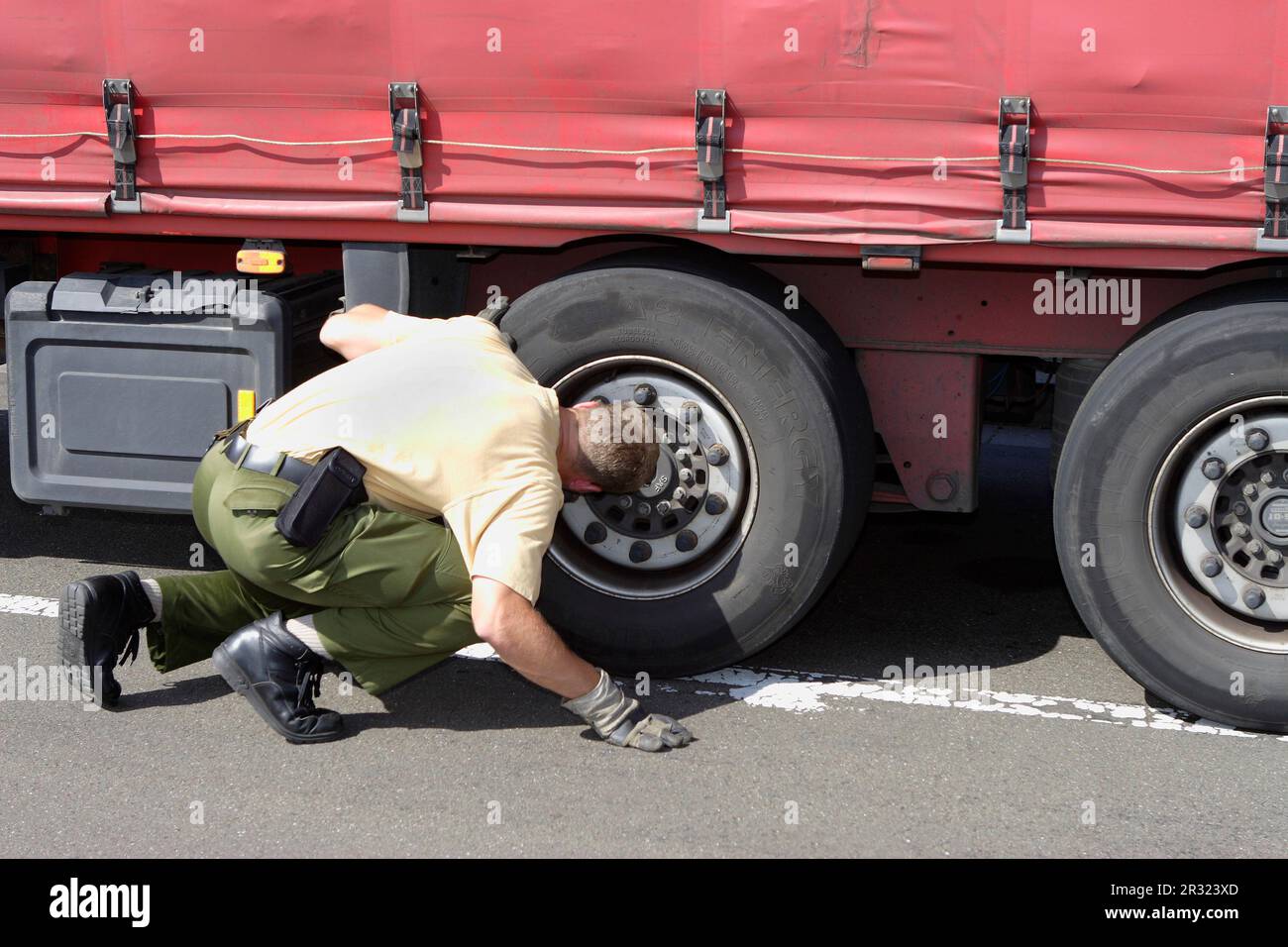 Policeman checks truck Stock Photo - Alamy