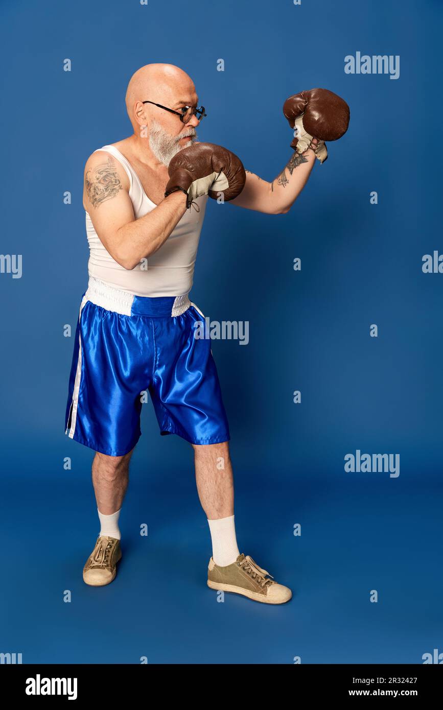Boxing sport. Portrait of bald, bearded, mature man in sportswear ...