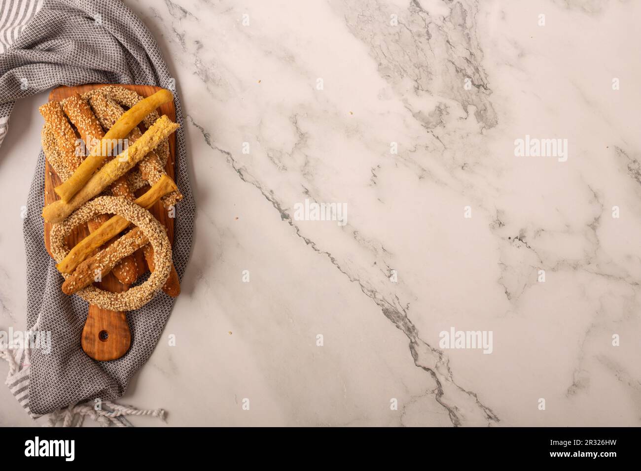 Freshly baked breadsticks on a wooden board. Copy space. Top view ...