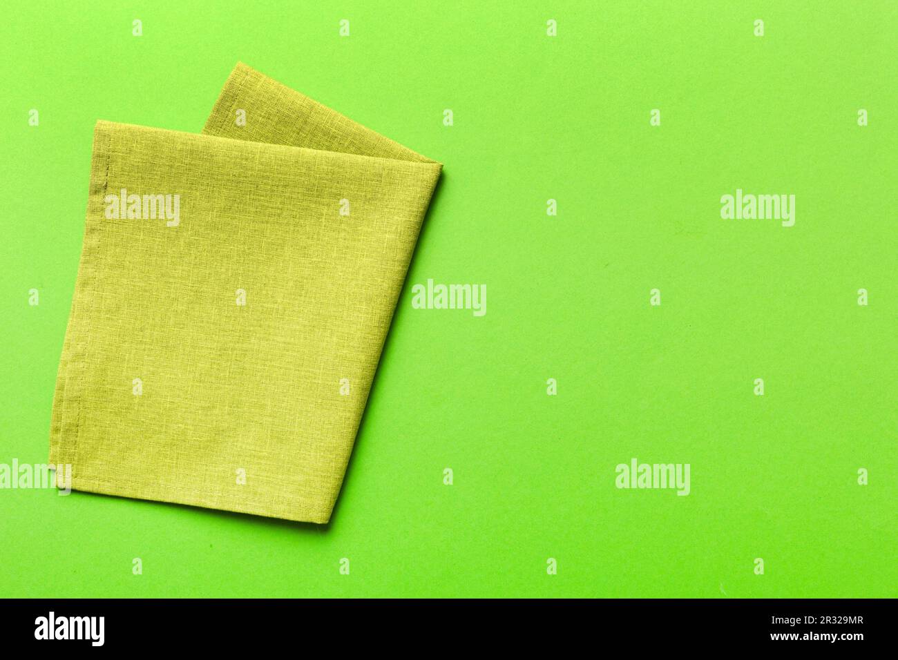 top view with green kitchen napkin isolated on table background. Folded ...