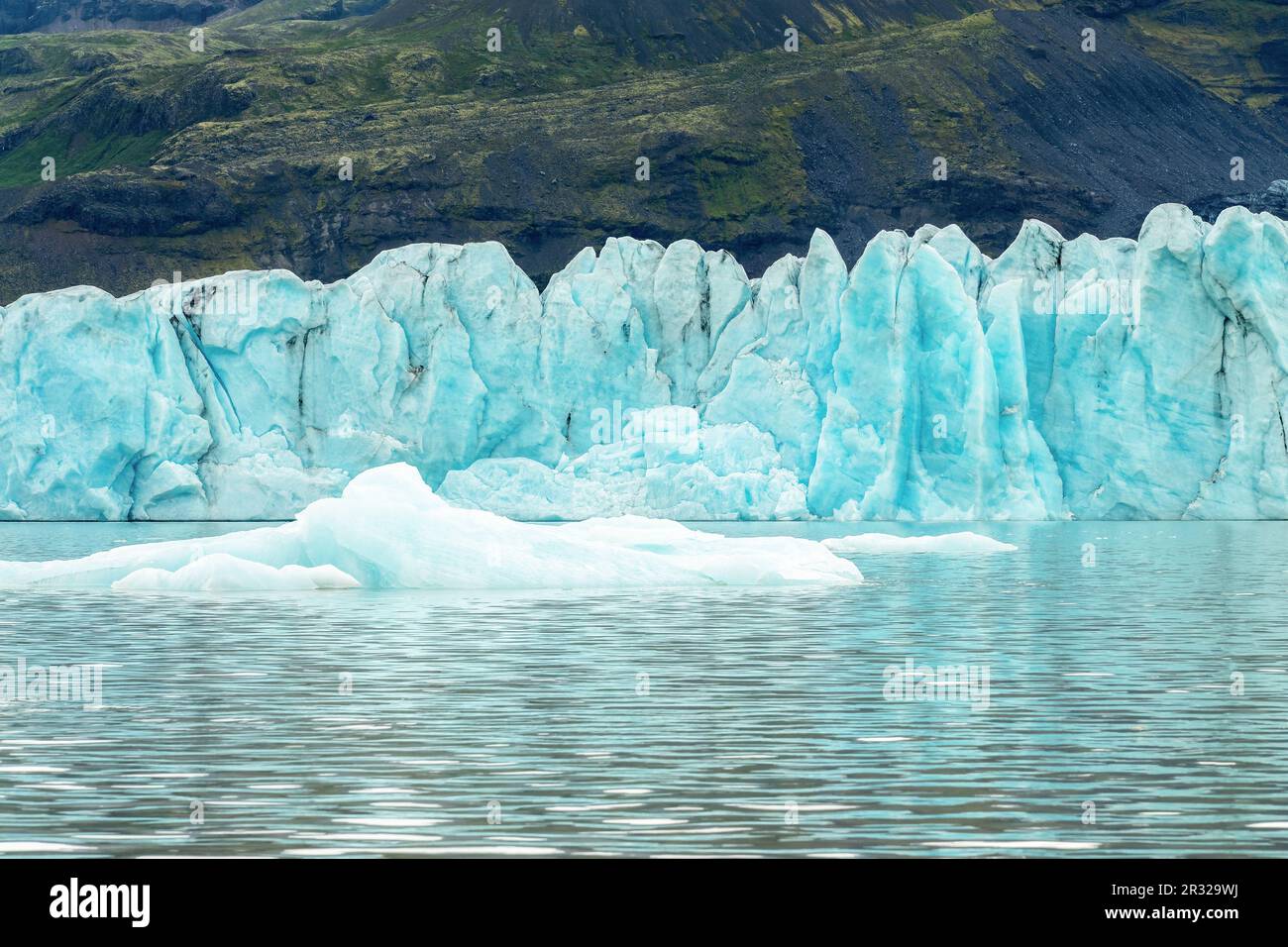 Ice wall and icebergs in Fjallsarlon glacier lagoon, abstract landscape ...