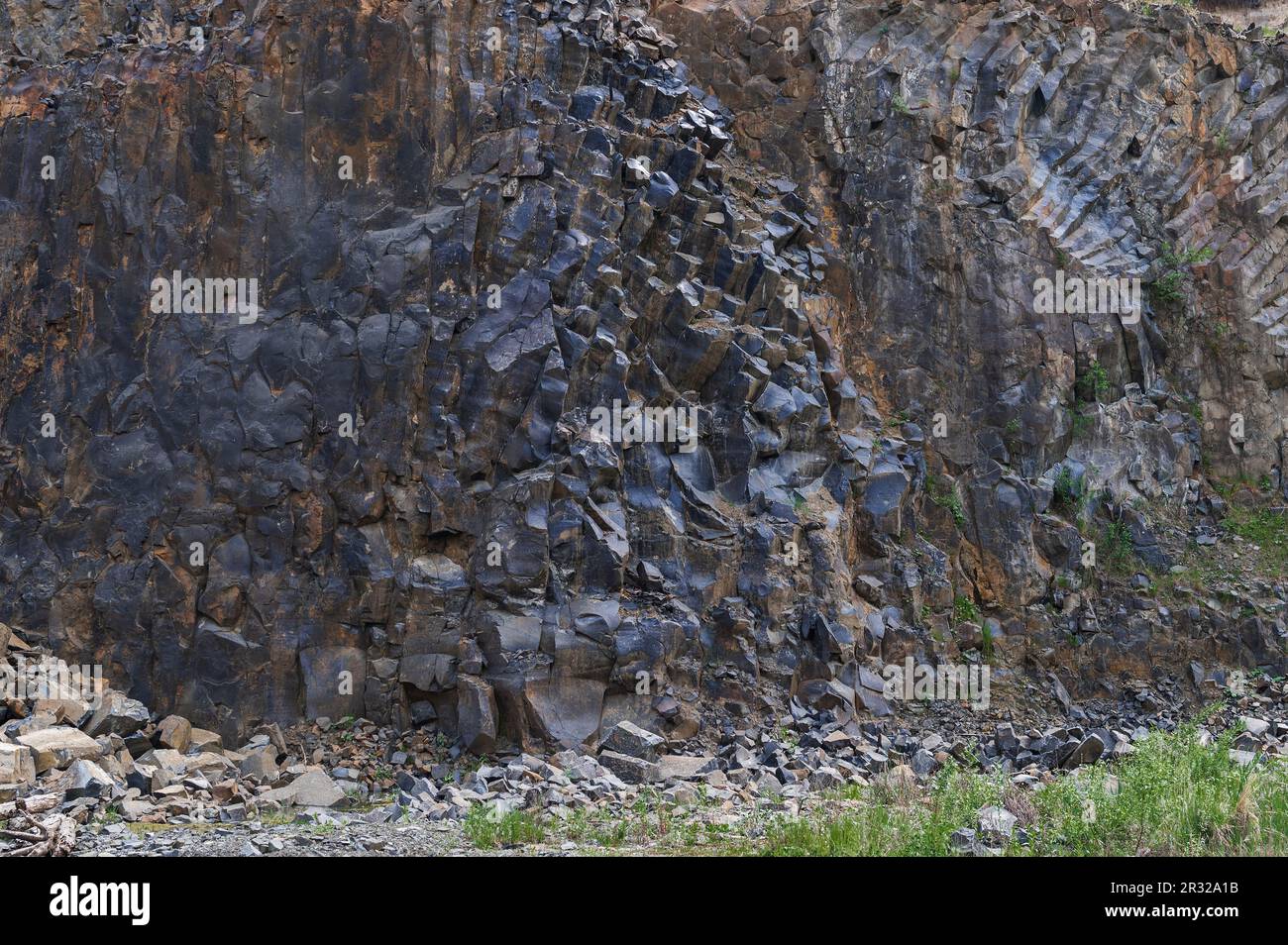 Basalt pillars in a quarry. Natural basalt rock columns closeup texture ...