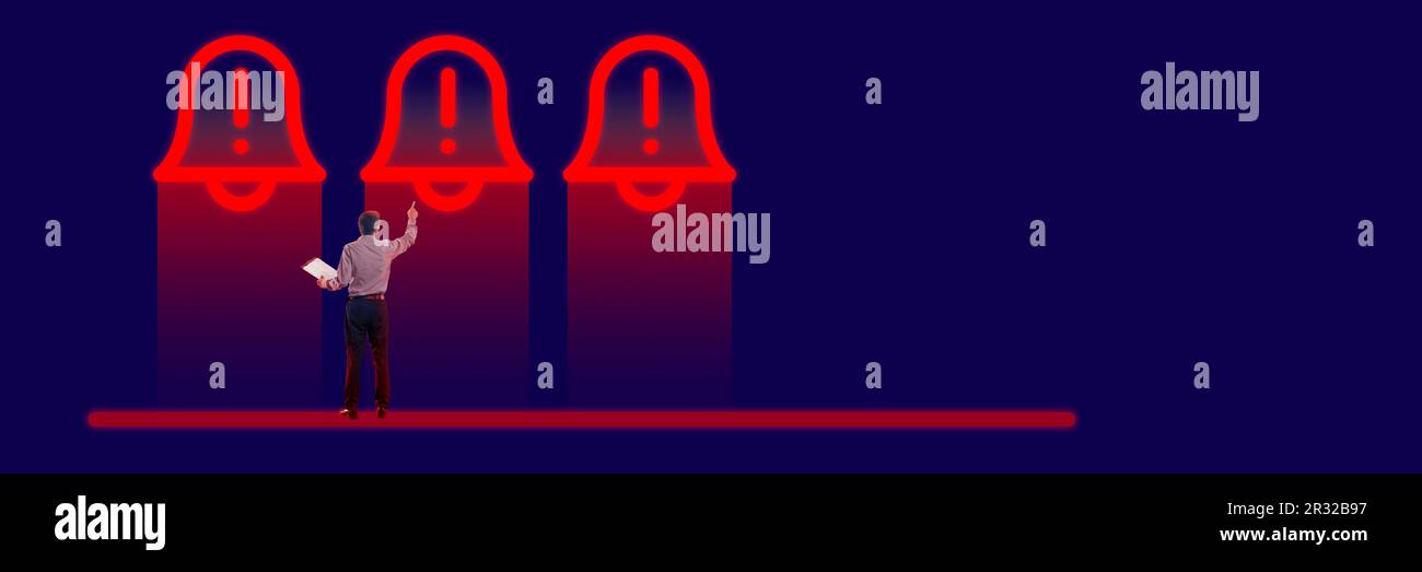 Businessman standing near giant neon colored bells symbolizing ...