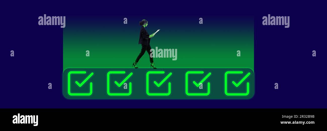 Businesswoman walking on neon colored icons of check marks symbolizing ...