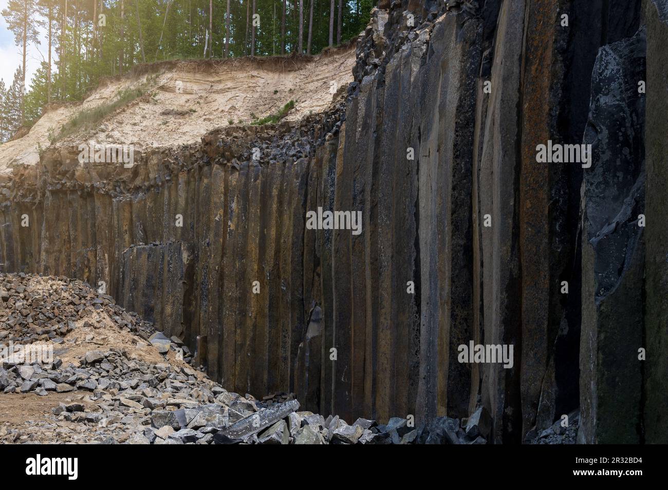 Basalt pillars in a quarry. Natural basalt rock columns closeup texture ...