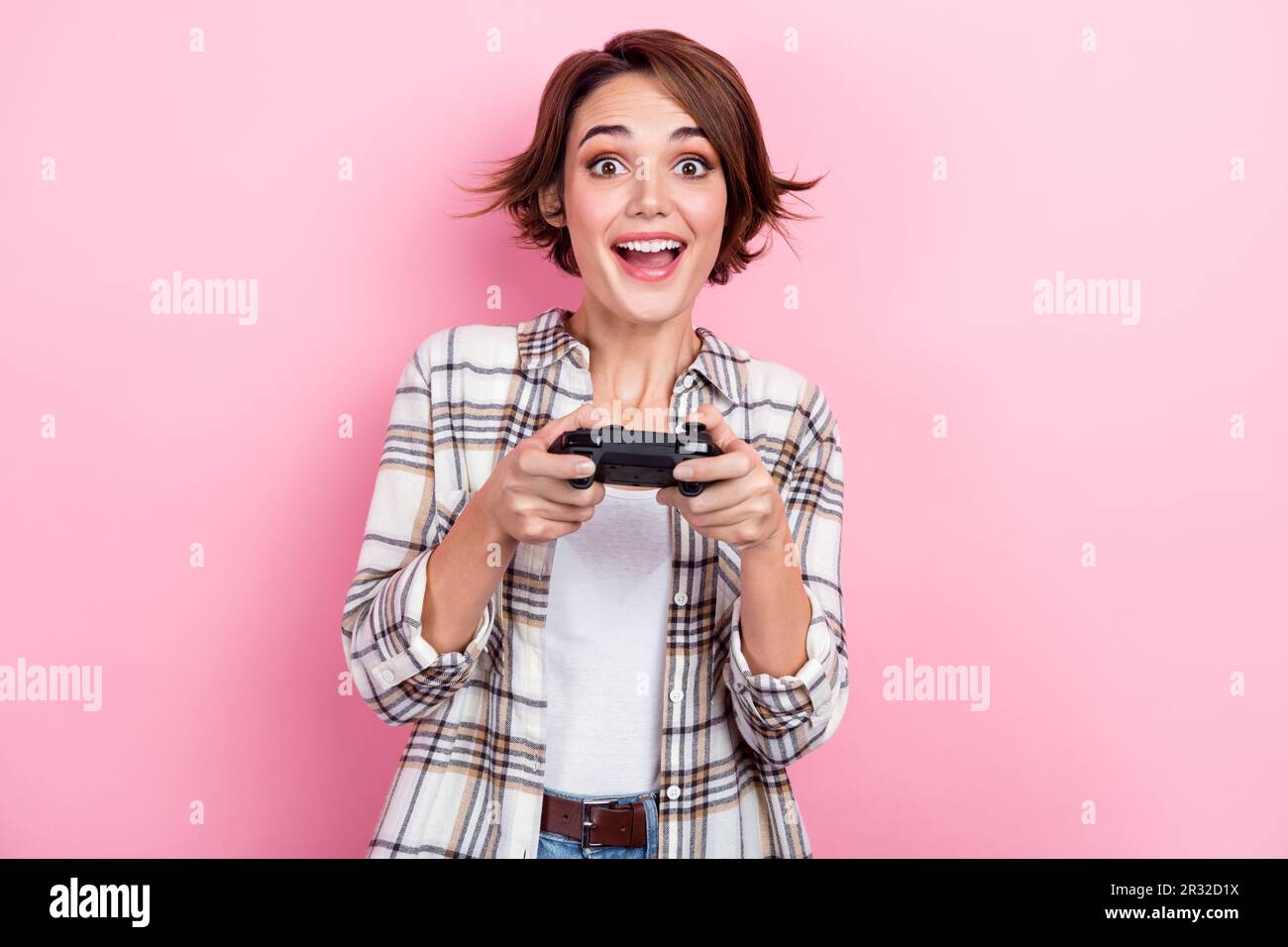 Portrait of positive pretty girl arms hold controller enjoy playing ...