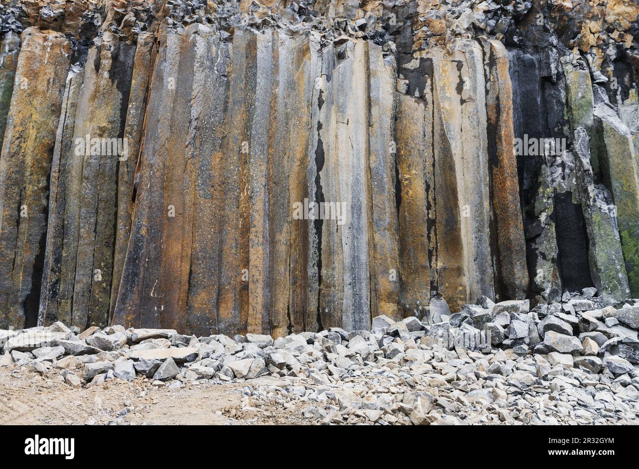 Basalt pillars in a quarry. Natural basalt rock columns closeup texture ...