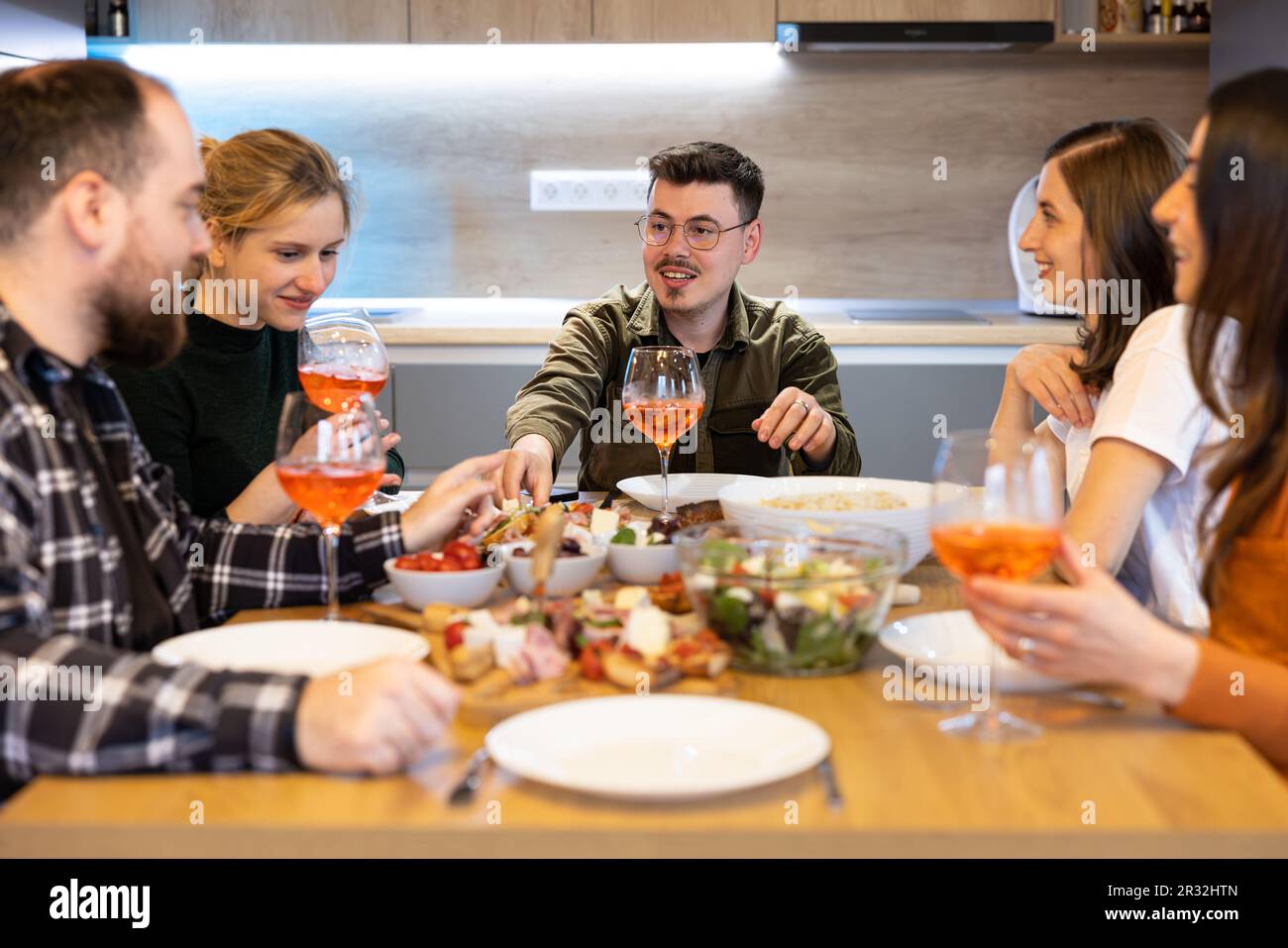Tradition to have dinner with friends at home Stock Photo - Alamy