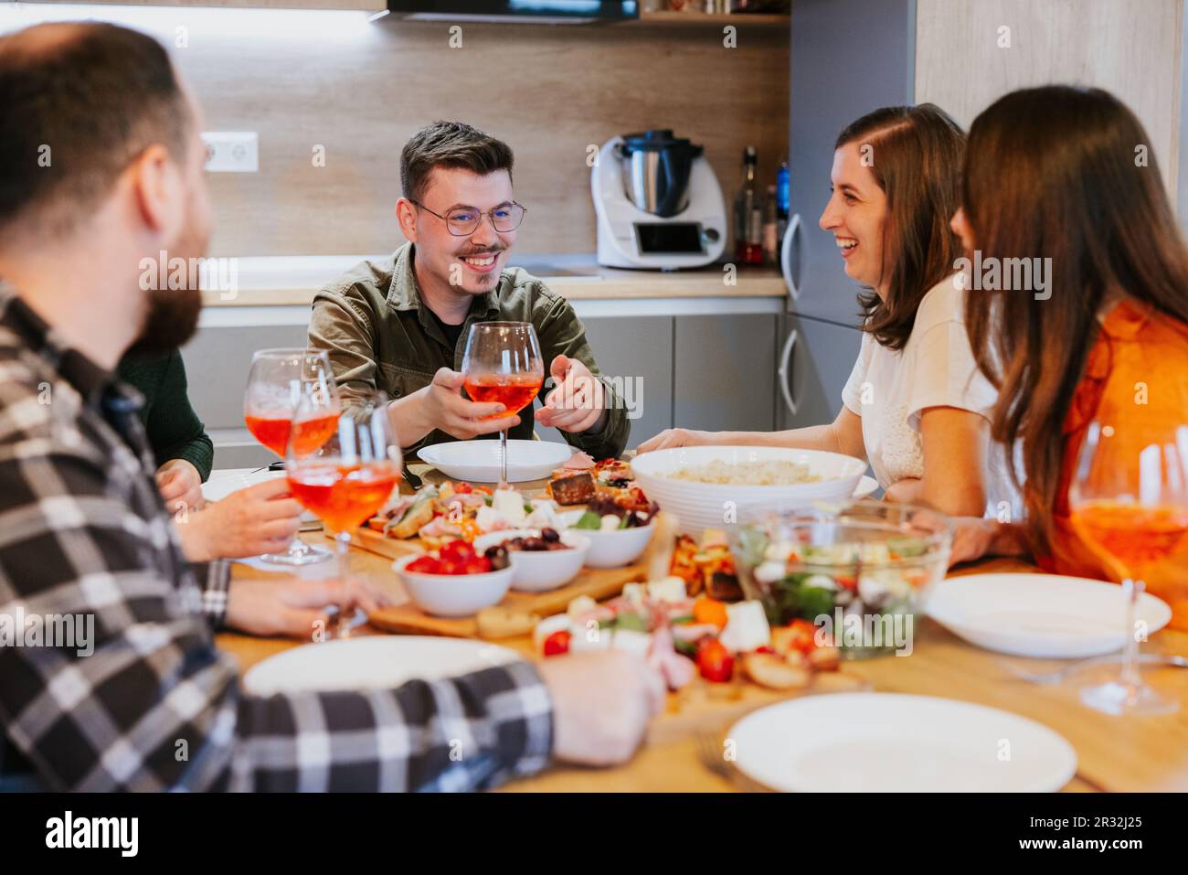 Tradition to have dinner with friends at home Stock Photo - Alamy