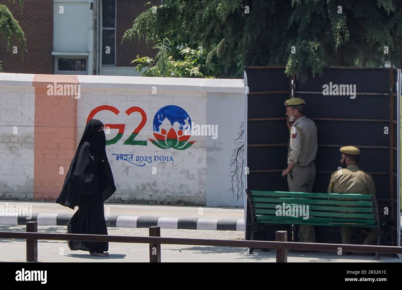Srinagar, India. 22nd May, 2023. A Indian Kashmir walks past a wall ...
