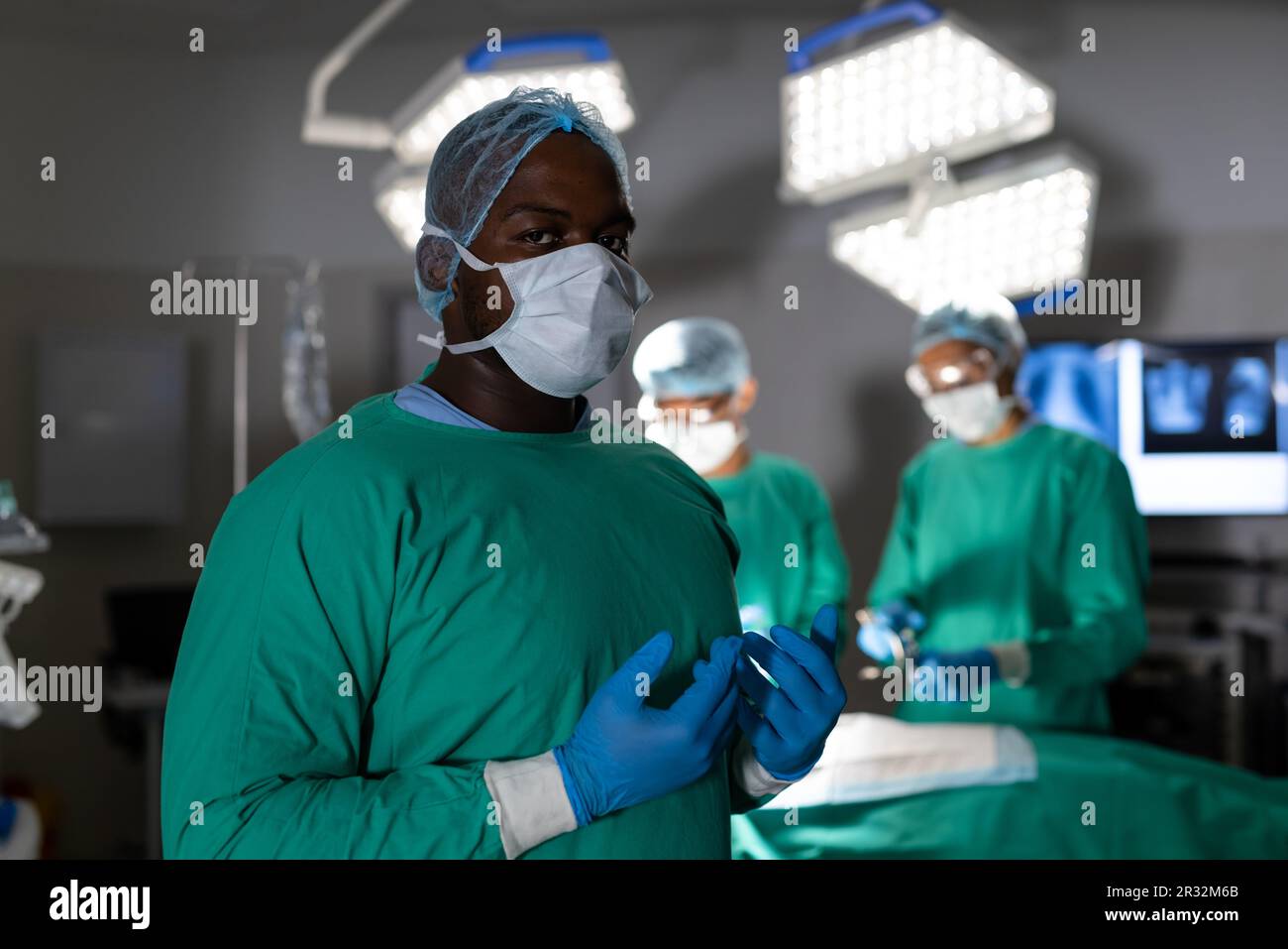 Portrait of african american male surgeon during surgery in operating ...