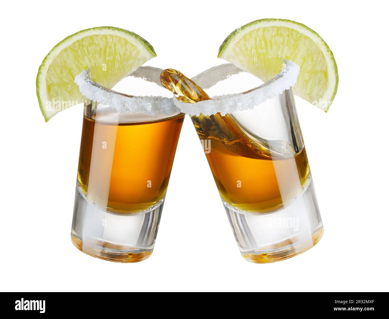 glasses shot of tequila with salt and lime making toast with splash ...