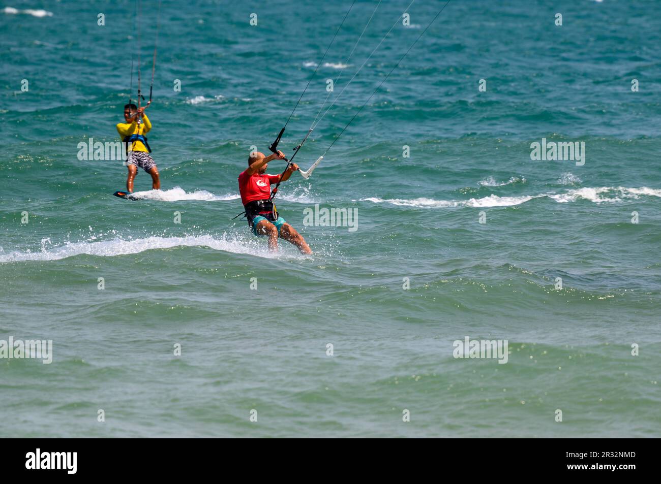 Two kitesurfers in action off the beach in Mui Ne, Vietnam Stock Photo ...