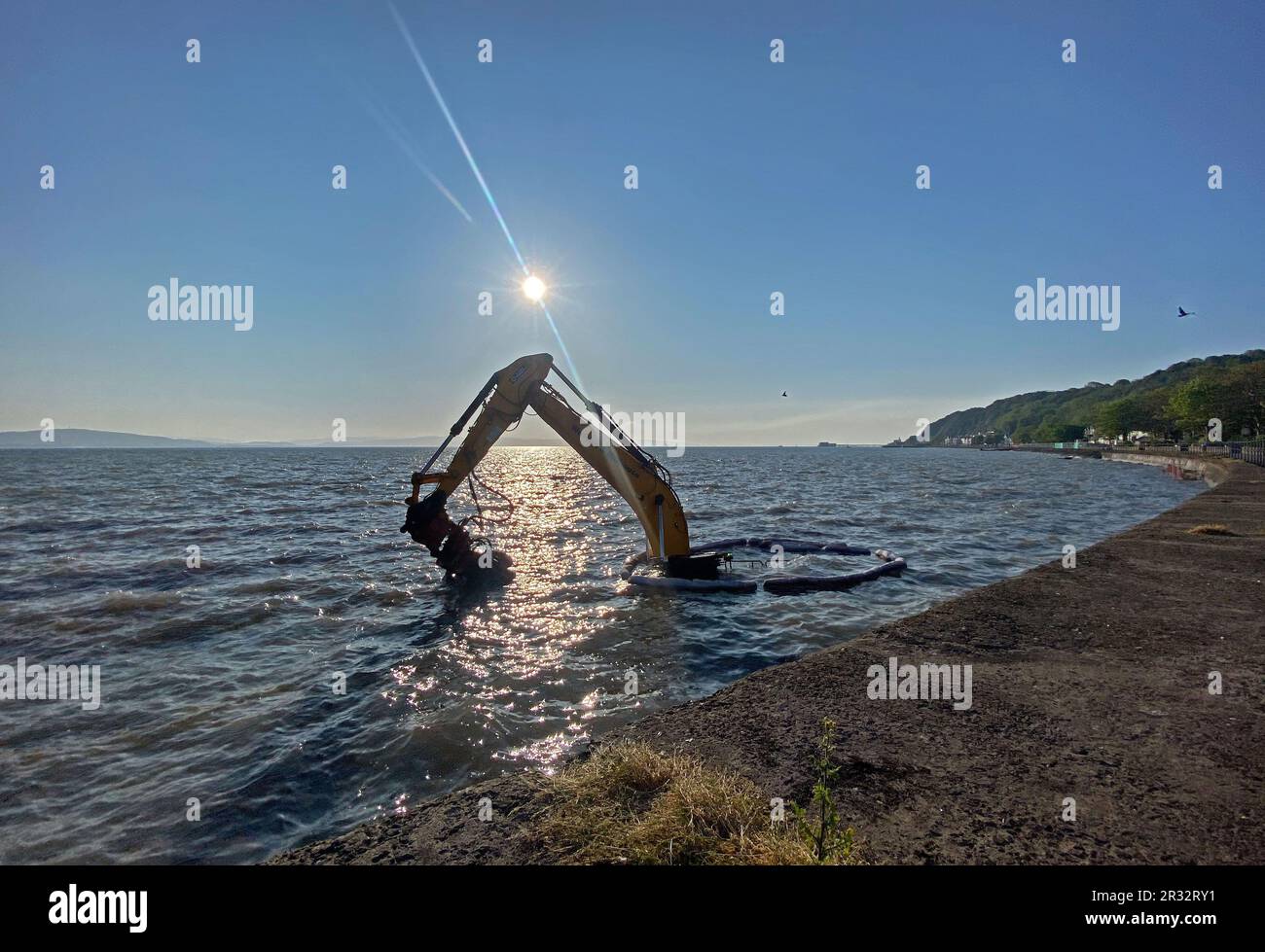 The mechanical digger which ended up submerged at high water in Mumbles ...