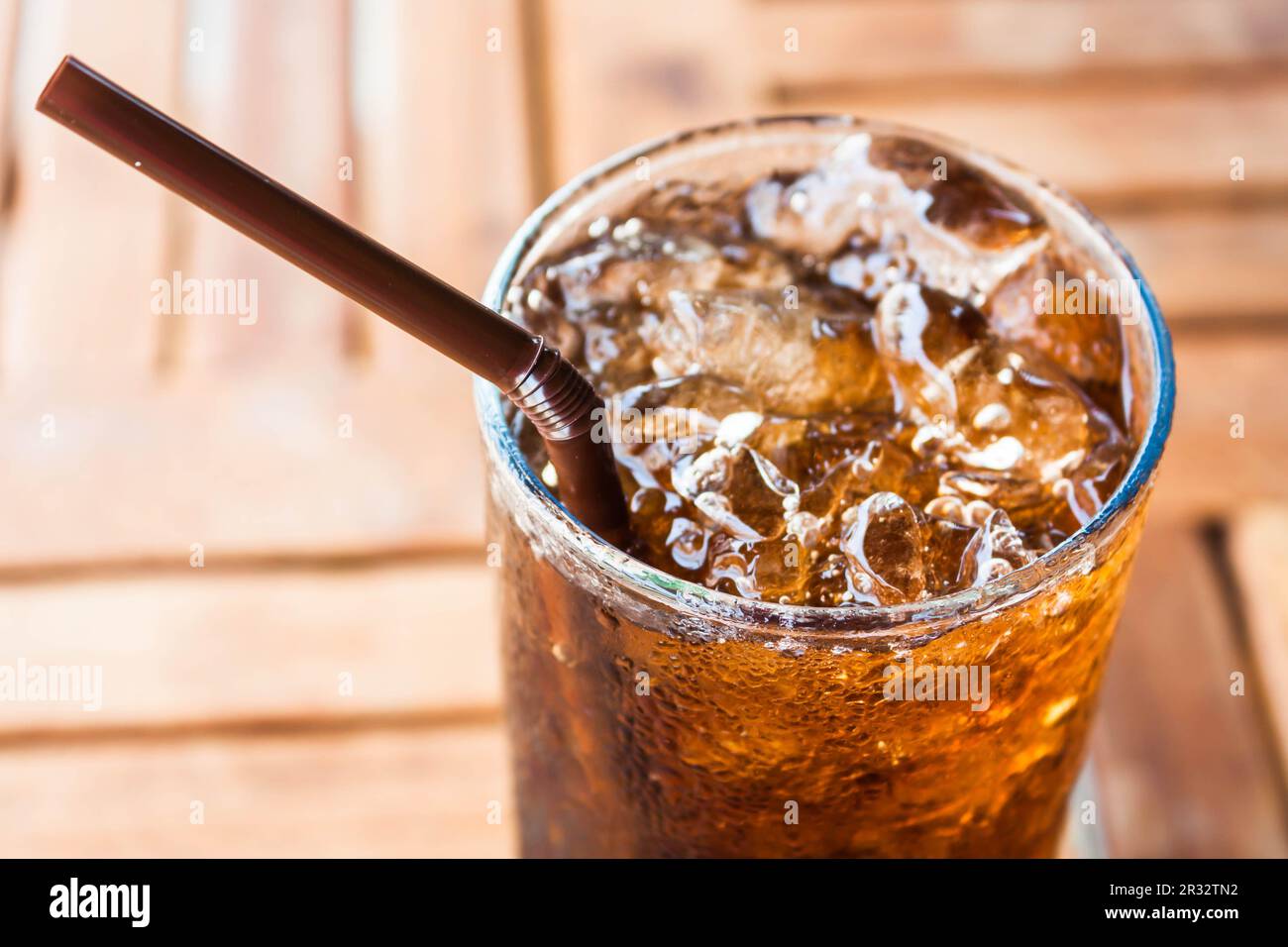 Cold glass with ice black soda drink Stock Photo - Alamy