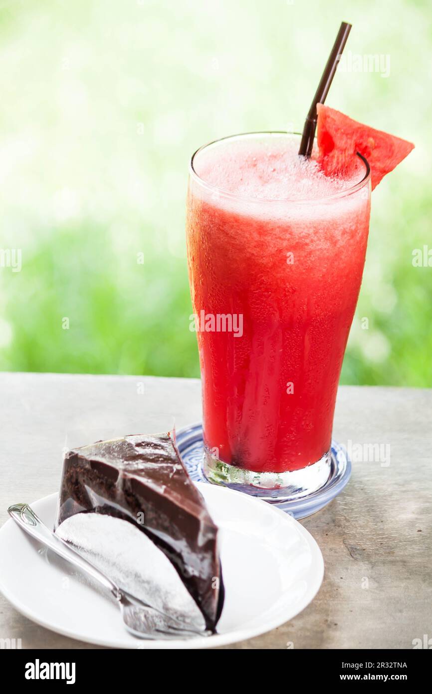 Break time with water melon fruit juice and chocolate cake Stock Photo ...