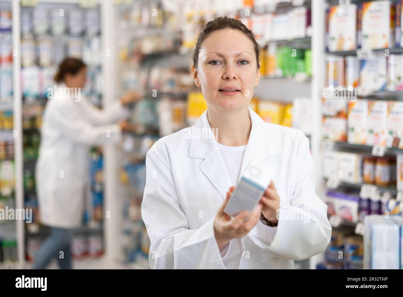 Female pharmacist offers various body care medicines Stock Photo - Alamy