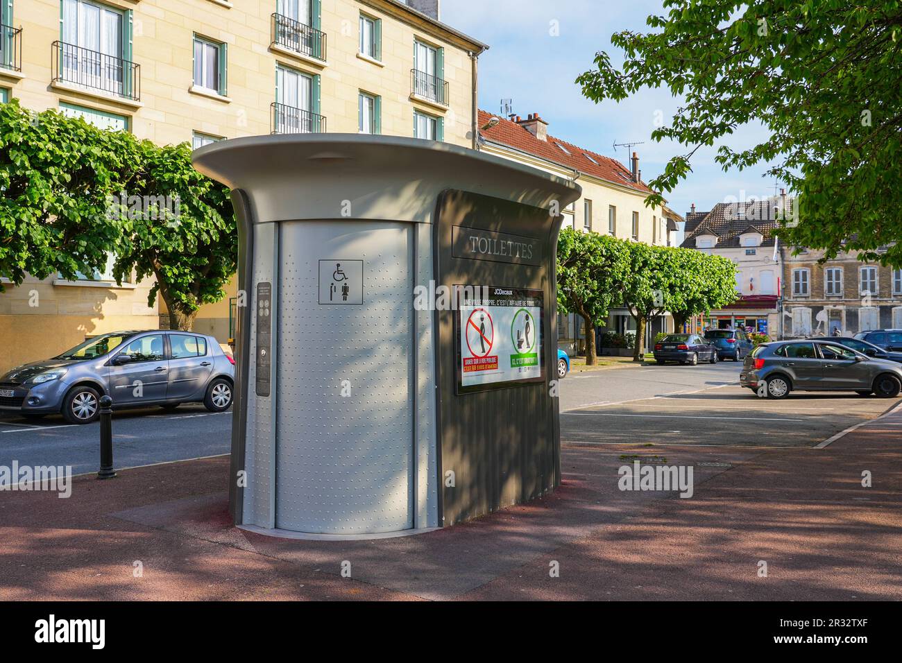 Automatic public toilet in a modern curved cabin on the sidewalk in the city center of Meaux in ...
